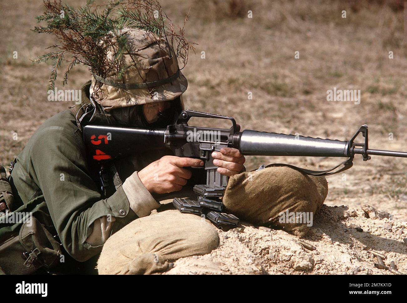 A U.S. Army soldier fires an M-16A1 rifle during a field exercise. He ...