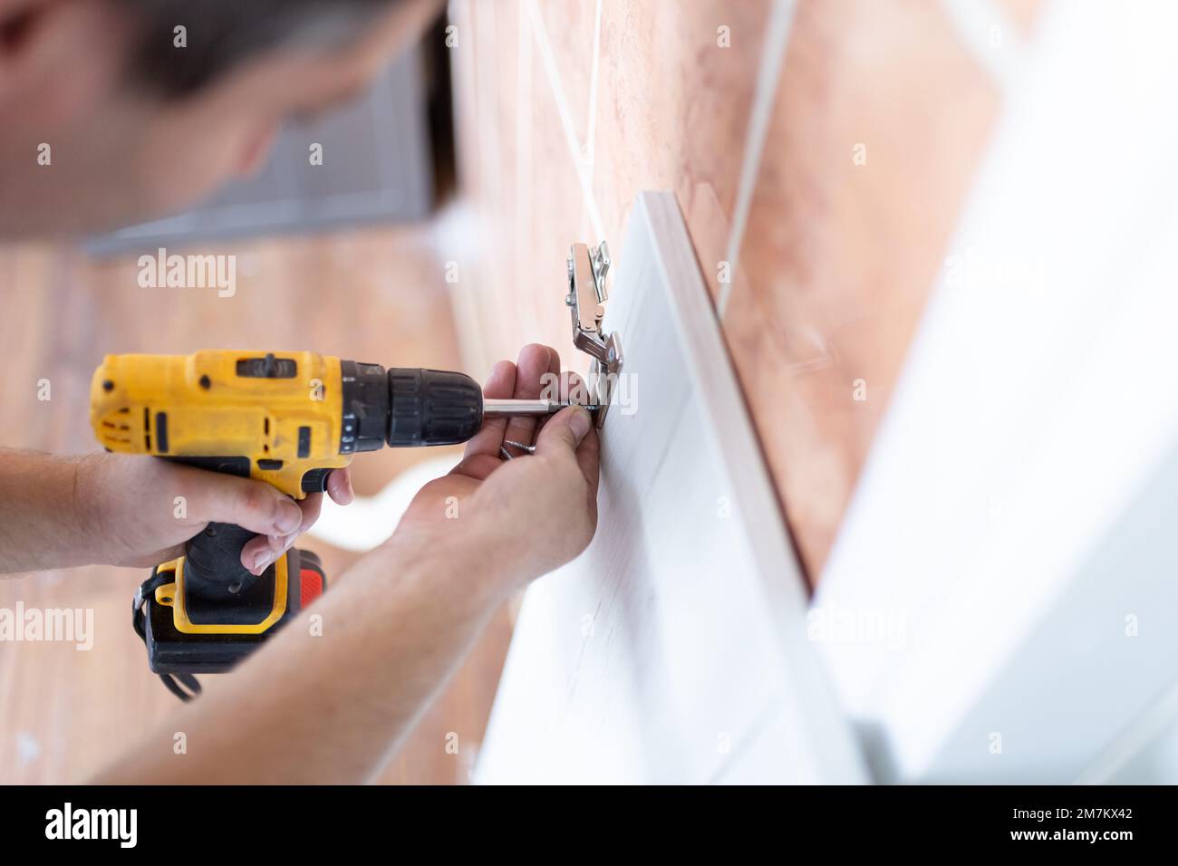 Man Assembling Shelf Using Electric Drill Tool At Home Male Housework