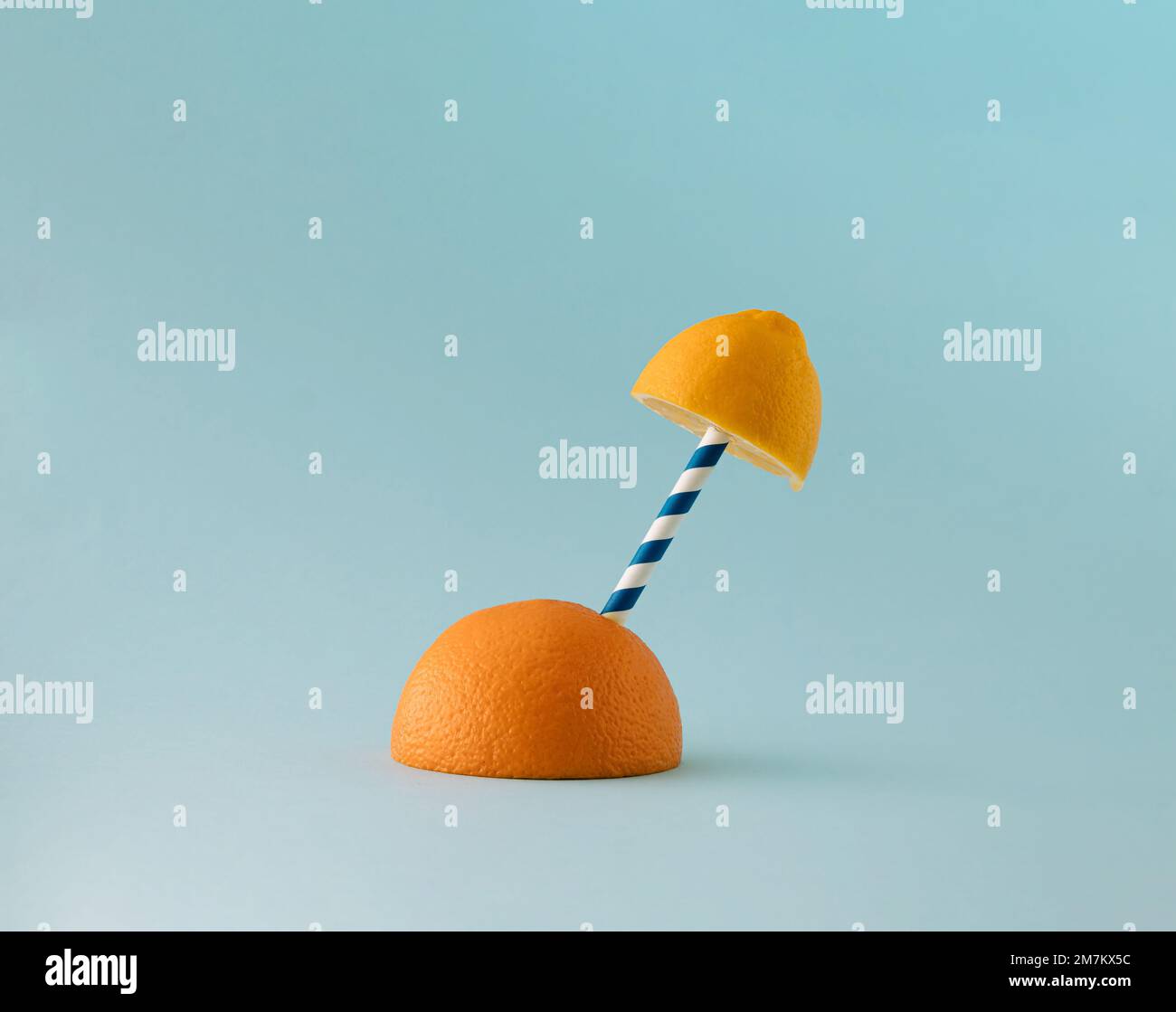 Fresh orange, lemon and paper straw in form of island and sunshade. Minimal summer concept Stock ...