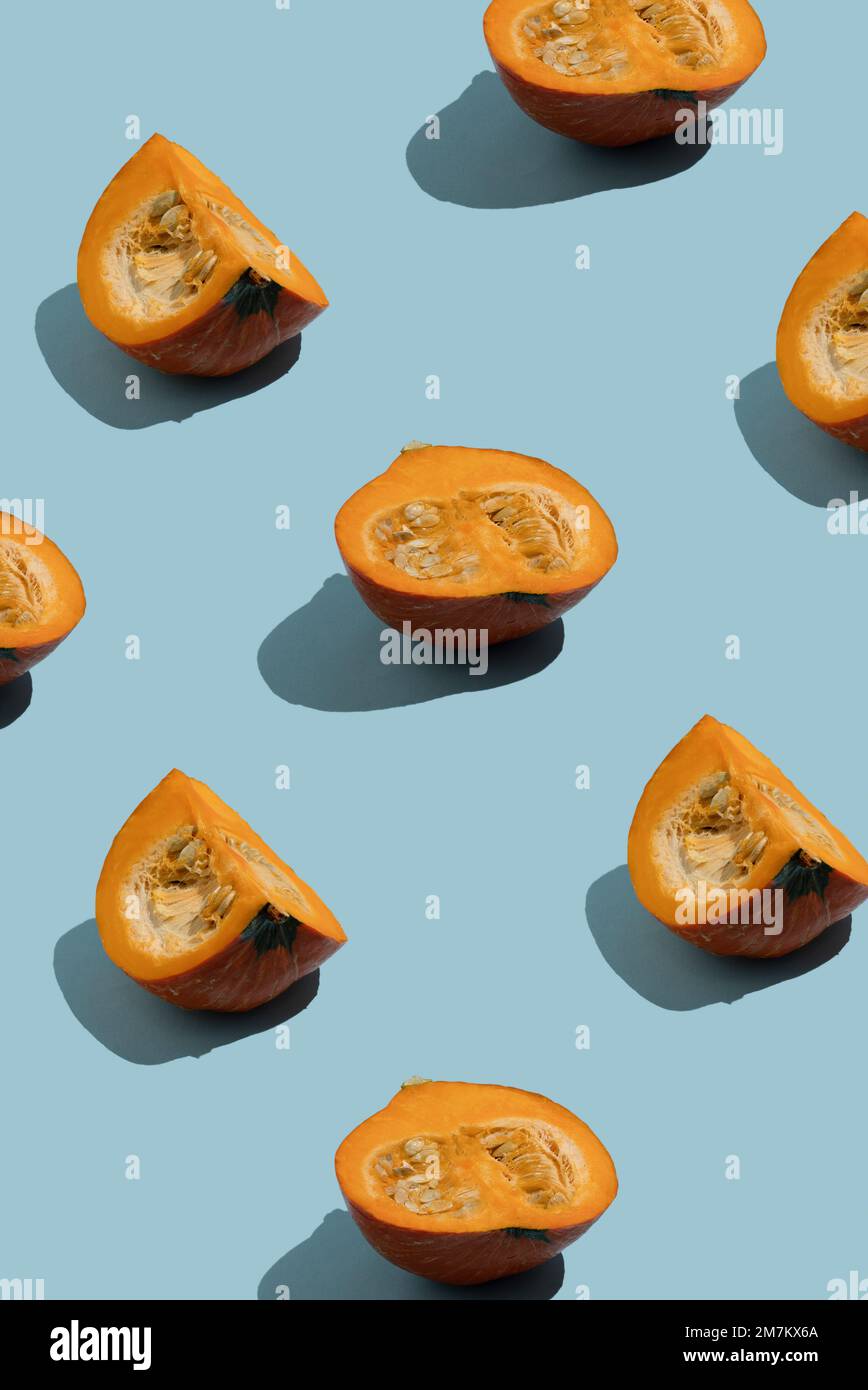 Pattern made of sliced fresh pumpkin on blue background. Minimal ...
