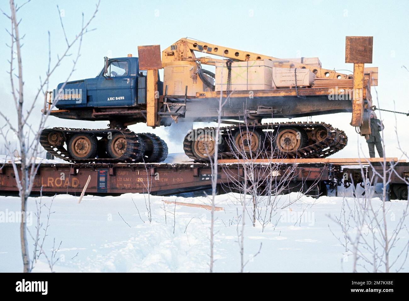 Left side view of a CU-Juggernaut crane on a flatbed railroad car. The ...