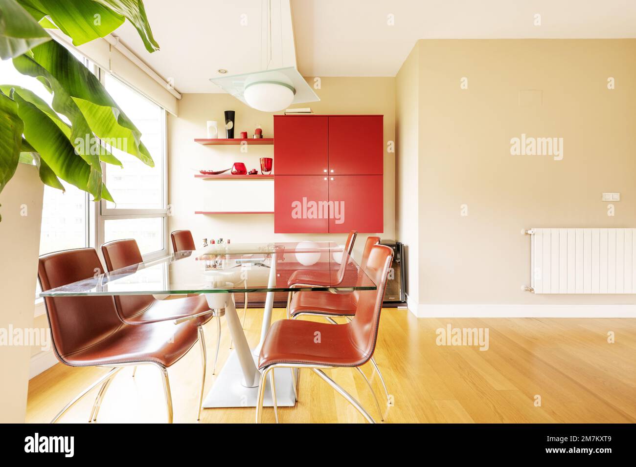 Dining room decorated with a glass table and chairs upholstered in ...