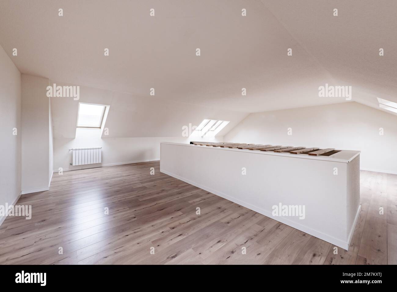 Empty room with white painted walls and chestnut parquet flooring and ...
