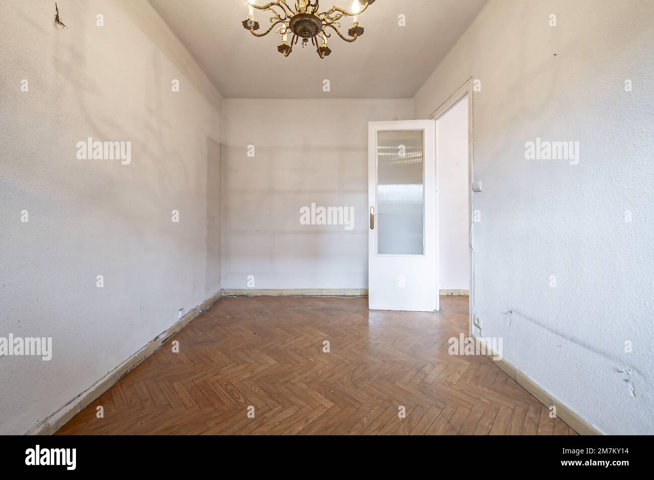 Empty room in an old flat with white wooden doors with glass and ...