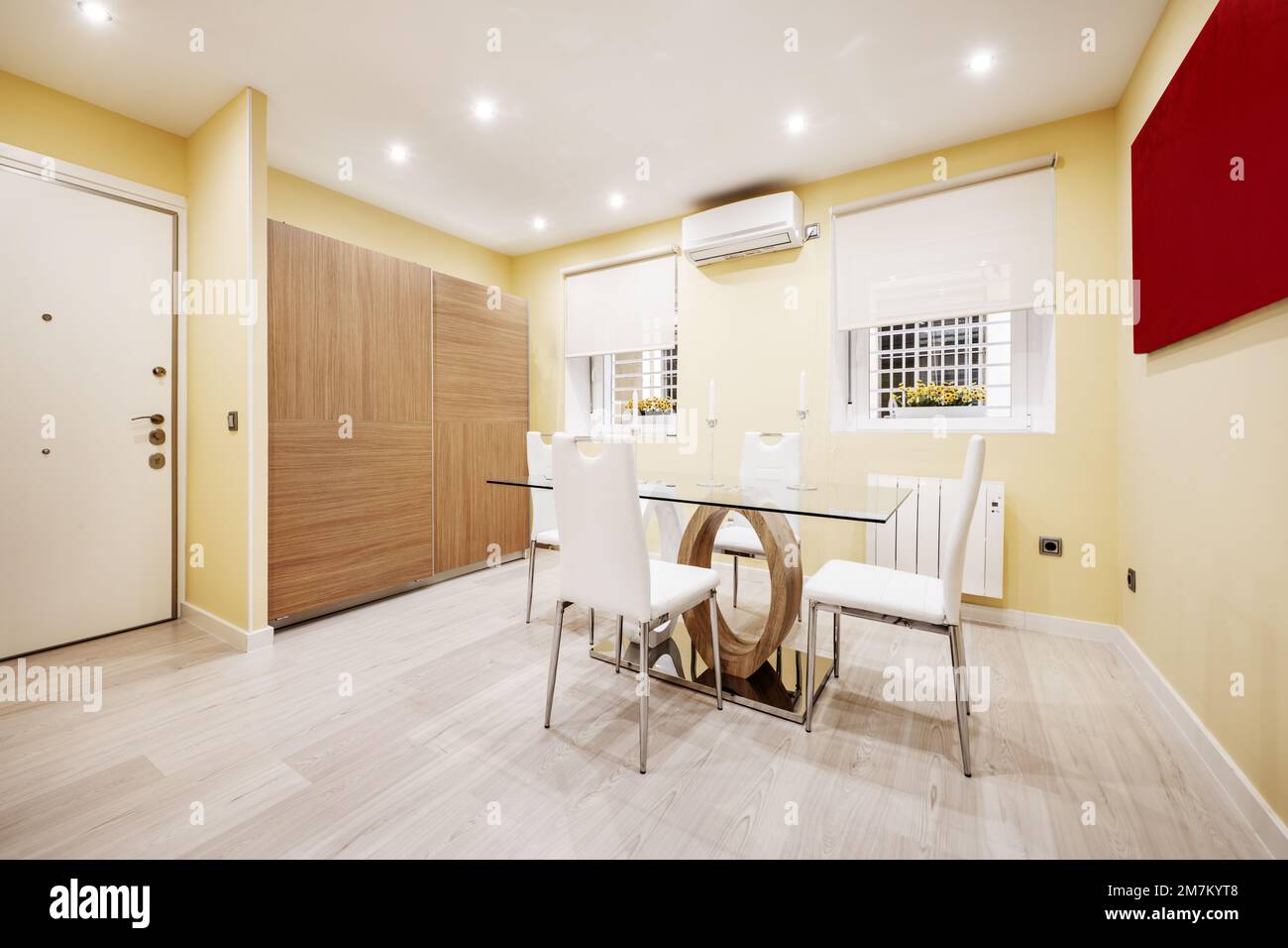 Living room with a glass table with white chairs in a room with ...