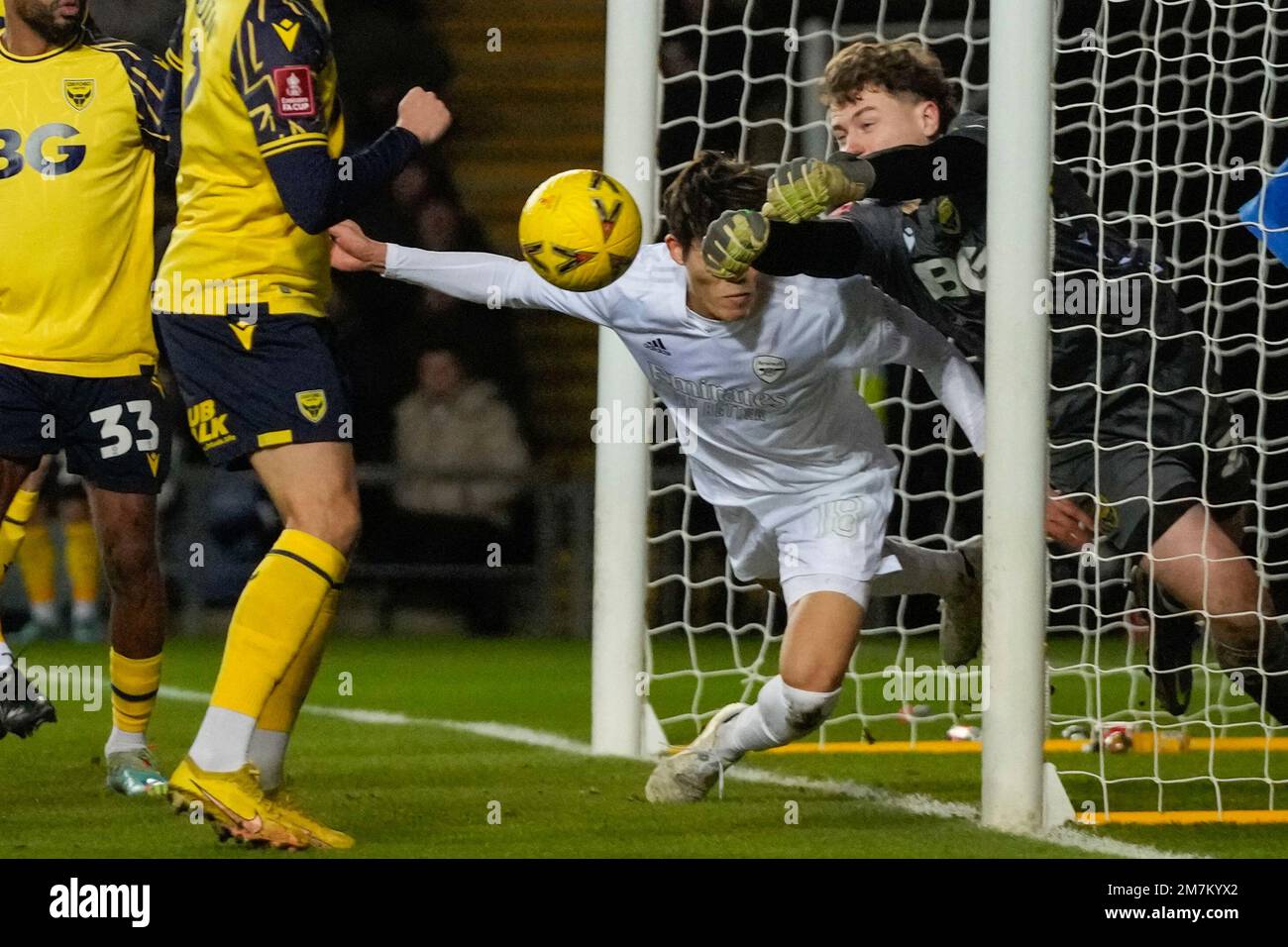 Oxford goalkeeper Edward McGinty, right, saves against Arsenal's ...