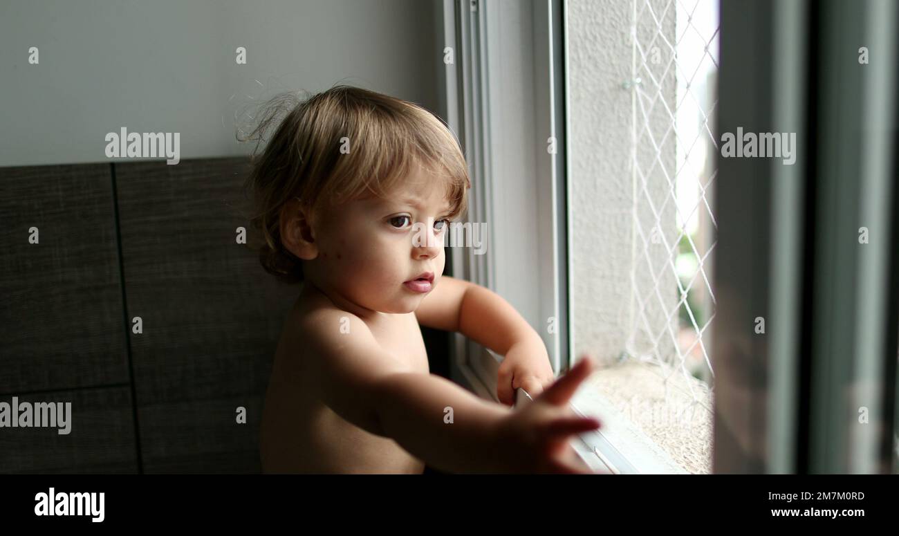 Child closing window, baby toddler boy shutting apartment window Stock ...