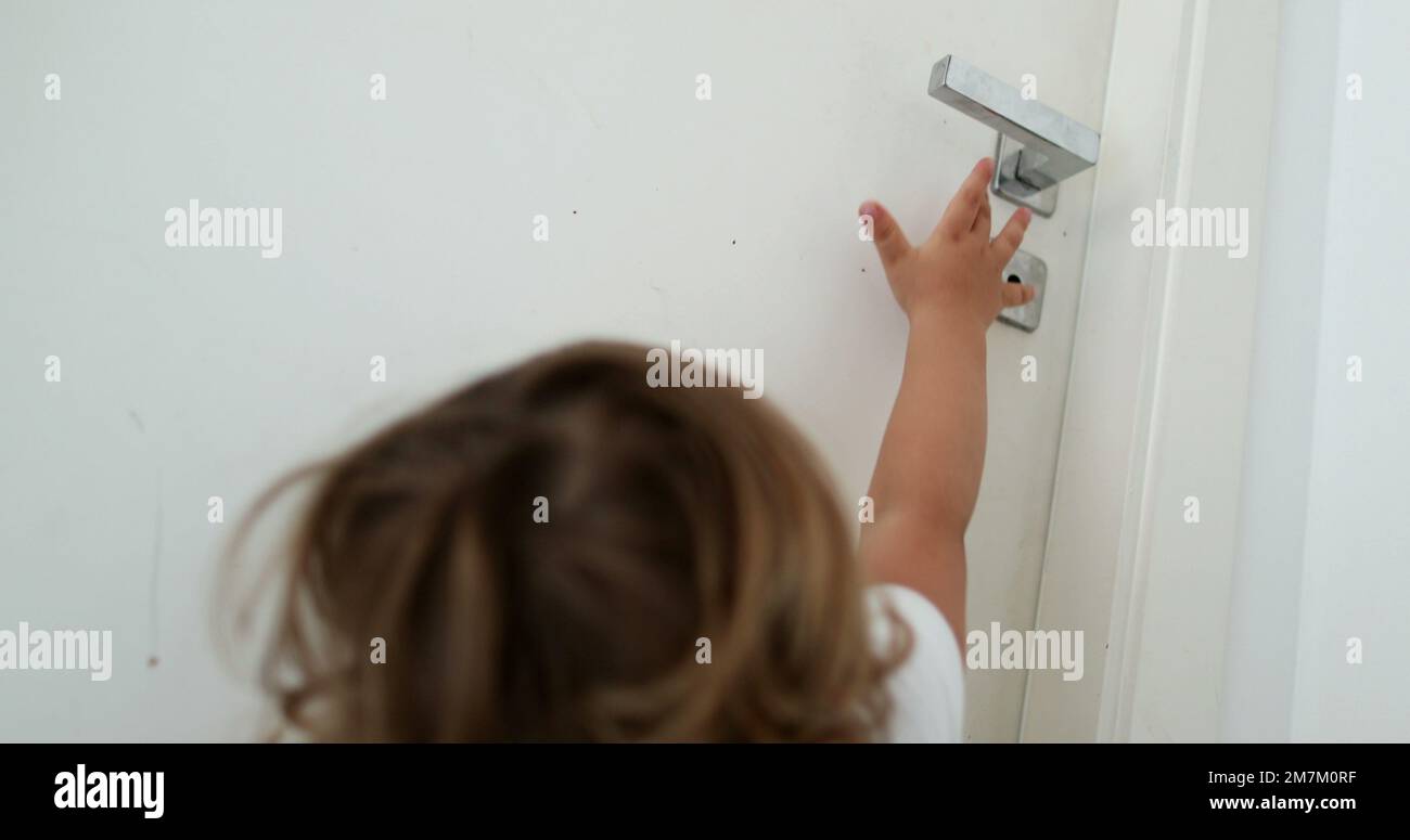 Baby trying to reach door knob. Child on tip toes reaching for door2 ...