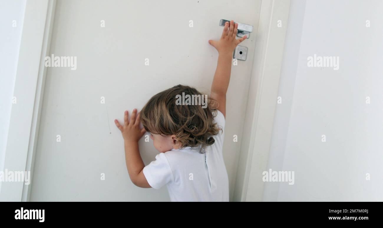Kid reaching door hi-res stock photography and images - Alamy