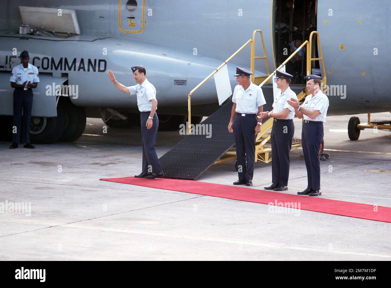 Ex-POW and unidentified U.S. Air Force LCOL waves to the crowd of well ...