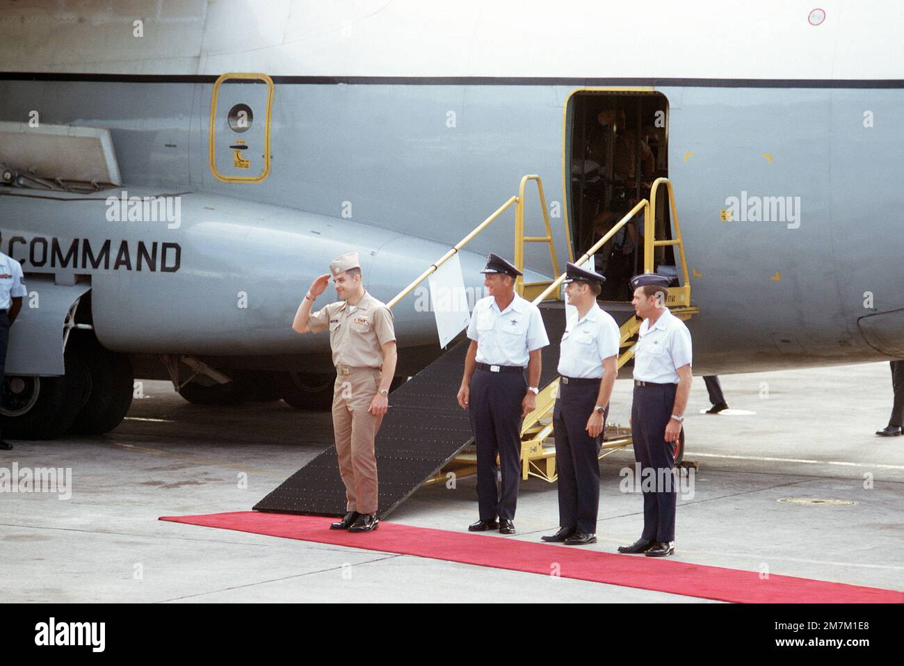 Ex-POW and unidentified U.S. Navy LT waves to the crowd of well wishers ...