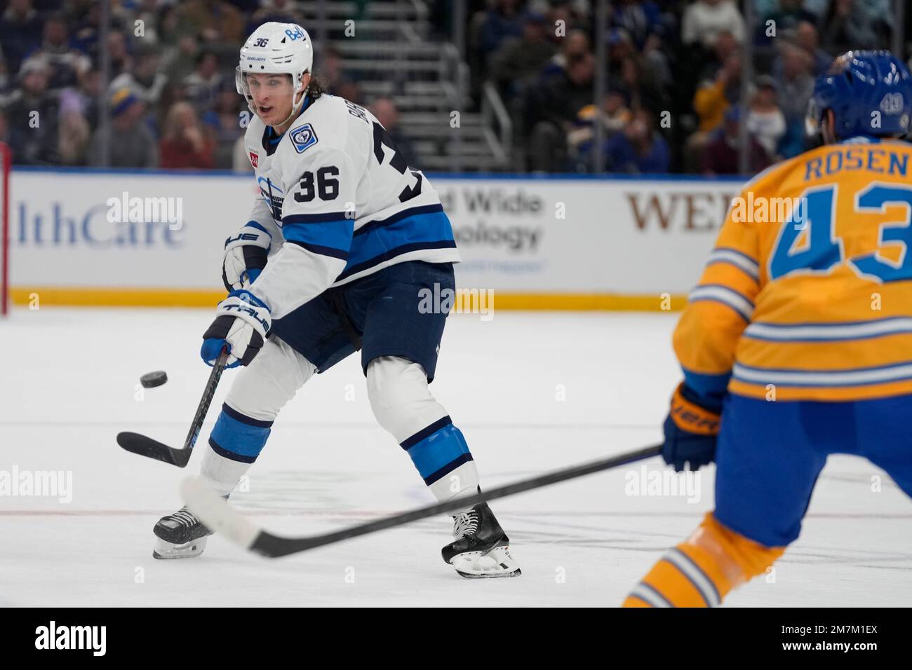 Winnipeg Jets' Morgan Barron (36) passes around St. Louis Blues' Calle ...