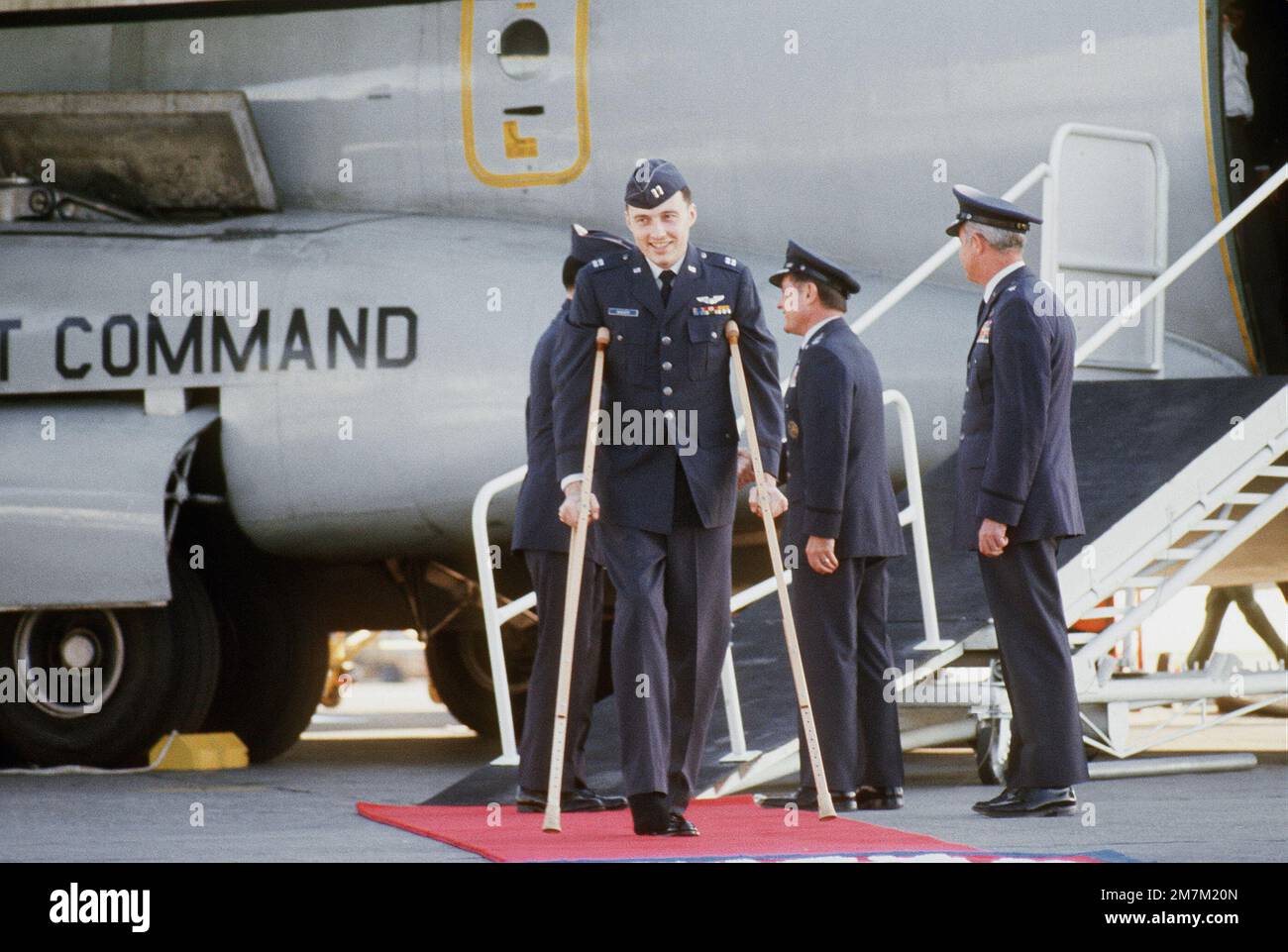 Former POW and U.S. Air Force CPT David Earle Baker, on crutches, walks ...