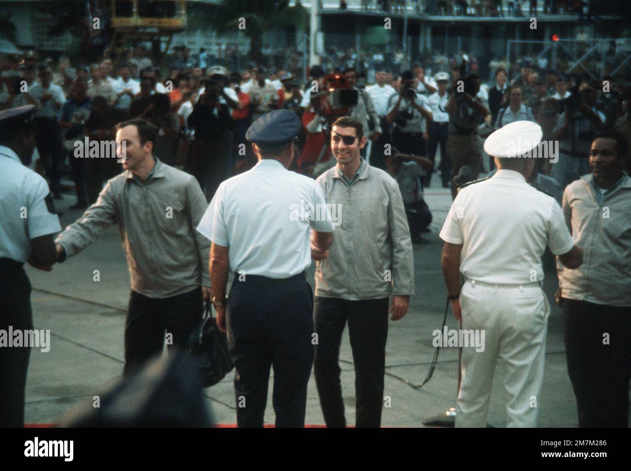 Ex-POWs are greeted upon arriving from Hanoi, North Vietnam, by (Left ...