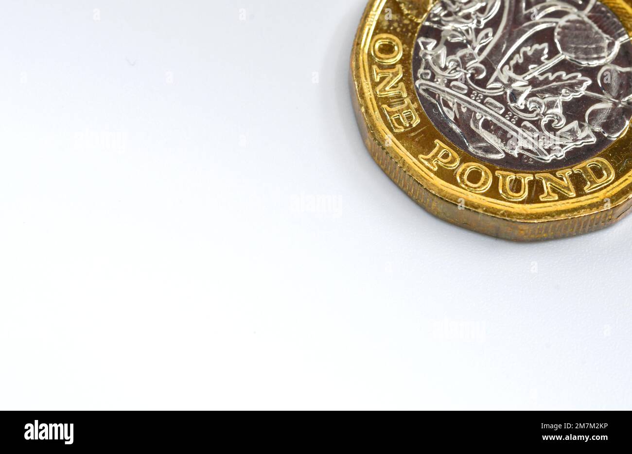 Corner of a British One Pound coin isolated on a plain white background ...