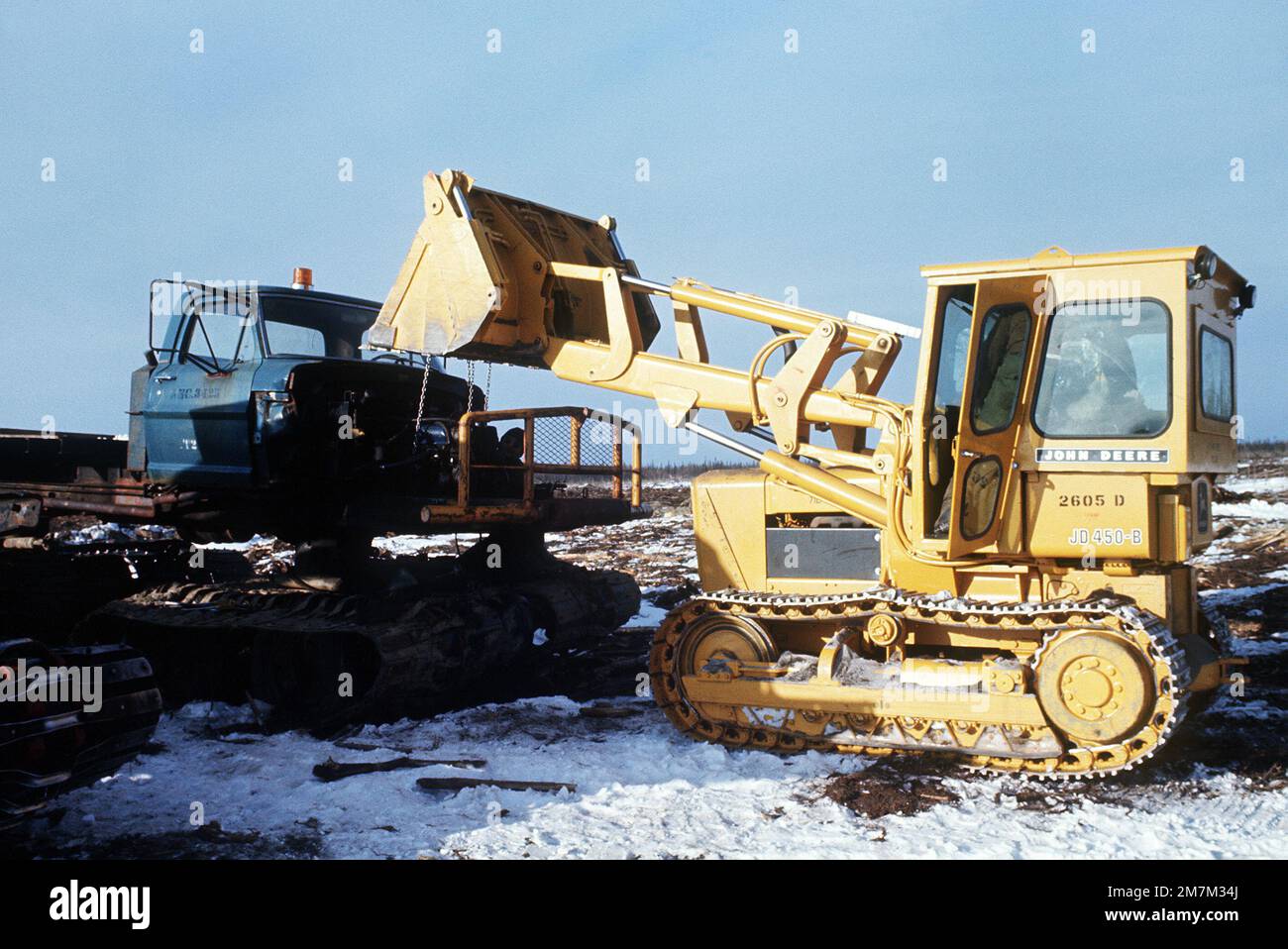 A front-end loader is used to remove the engine of a CU-Juggernaut for ...