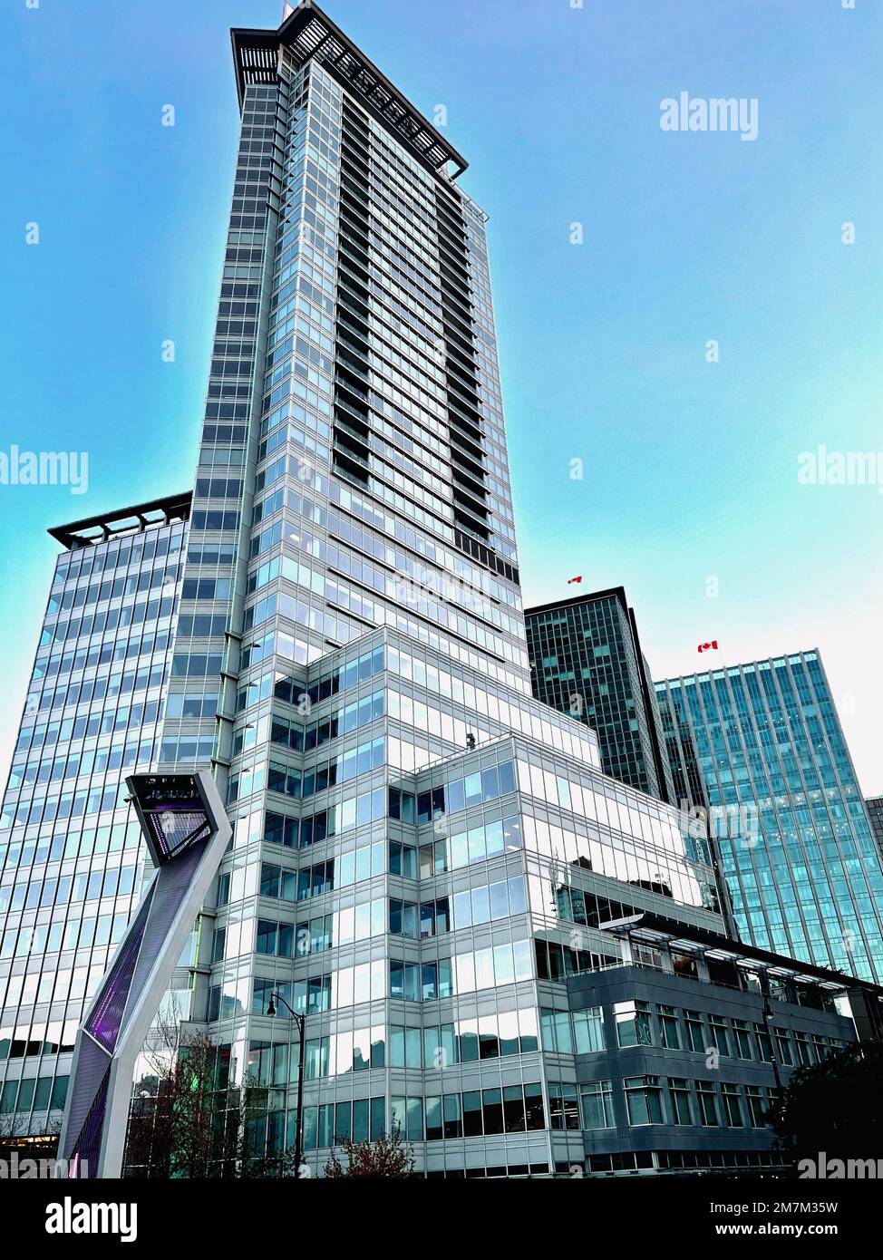 A low-angle shot of the Shaw Tower in Vancouver Canada against the blue ...