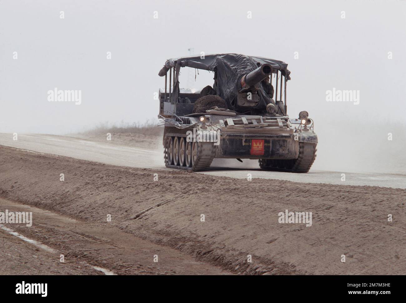 An M110 203 mm (8-inch) self-propelled howitzer moves down a road ...