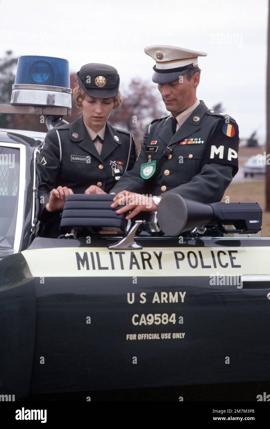 A U.S. Army Military Police School instructor shows a policewoman how ...