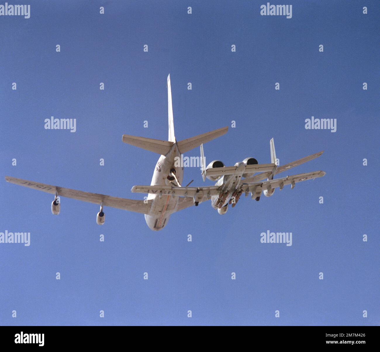 An air-to-air rear view of a YA-10 aircraft being refueled by a KC-135 ...