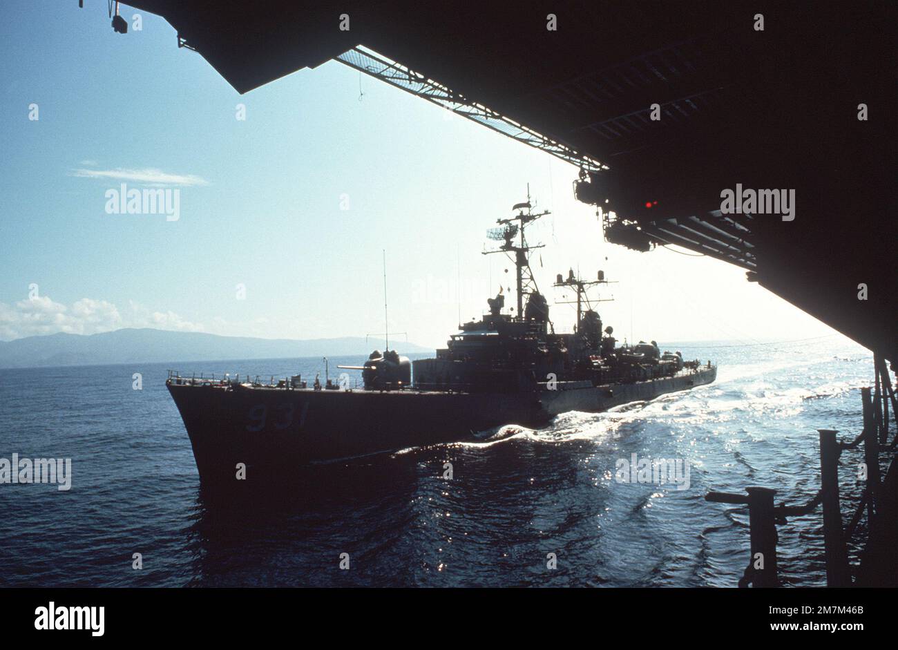 A port bow view of the destroyer USS FORREST SHERMAN (DD-931) alongside ...