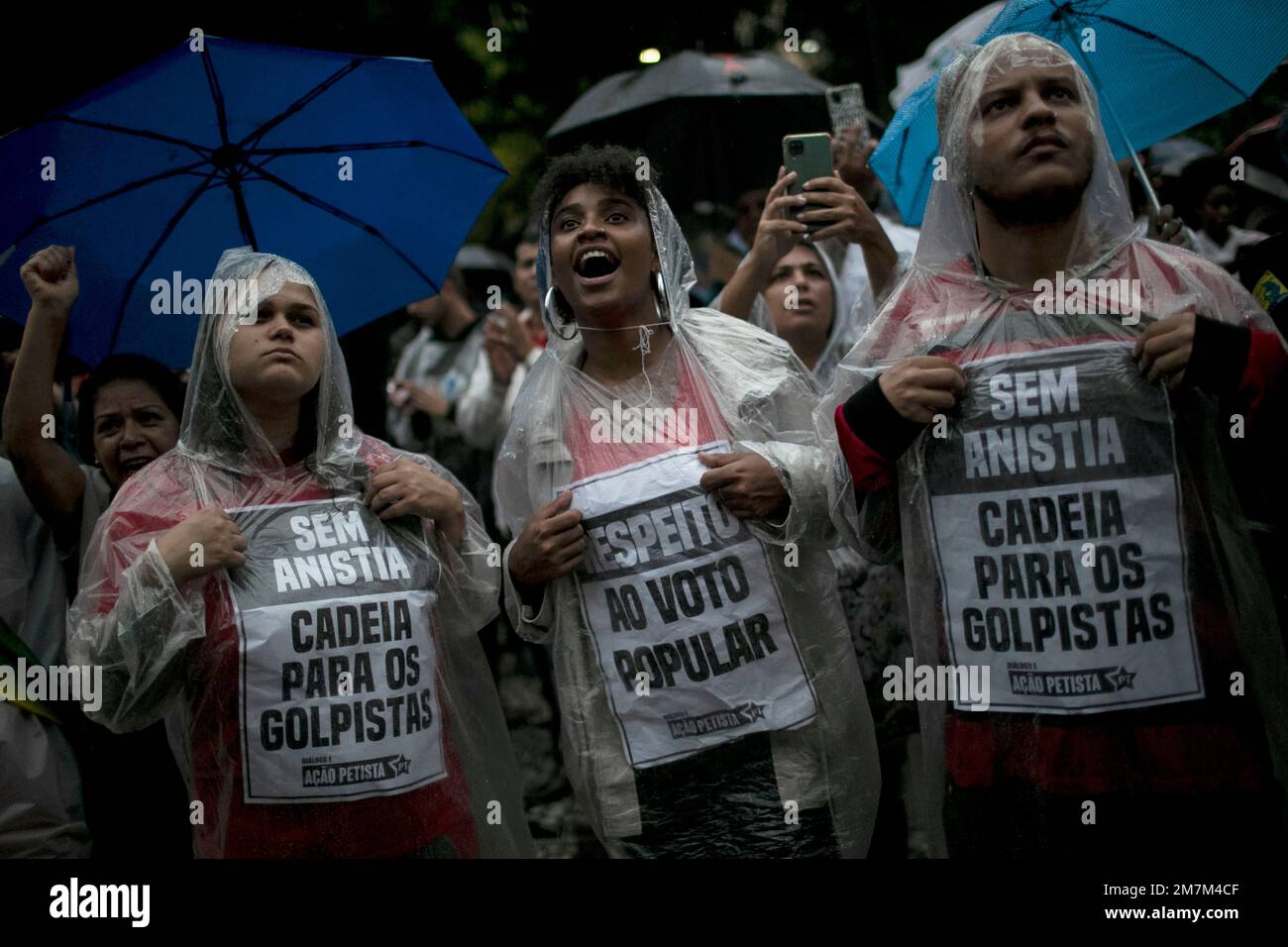 Protesters hold signs that read in Portuguese "Without anesthesia. Jail ...