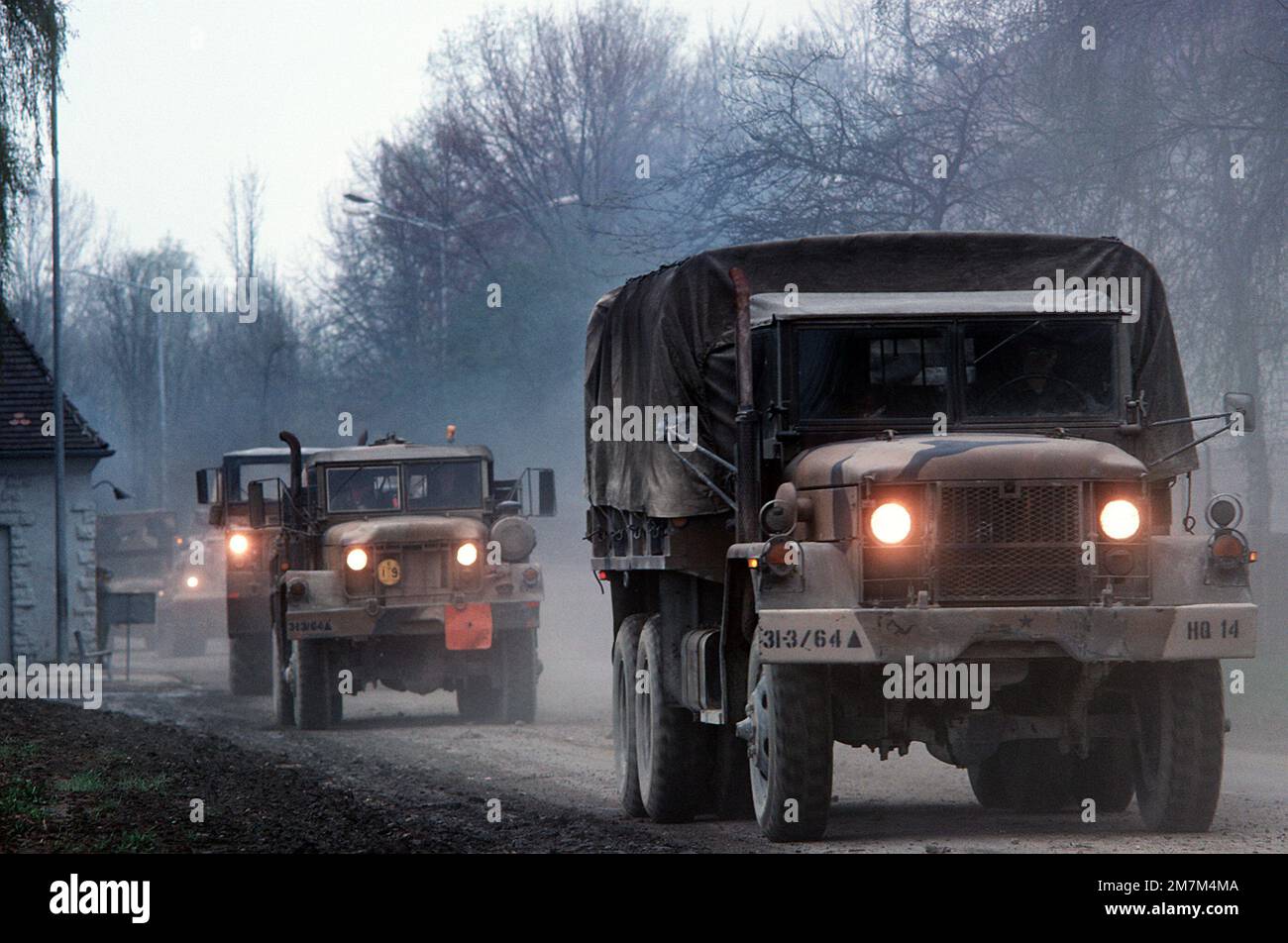 A U.S. Army M-35 cargo truck leads a convoy of vehicles. Country ...