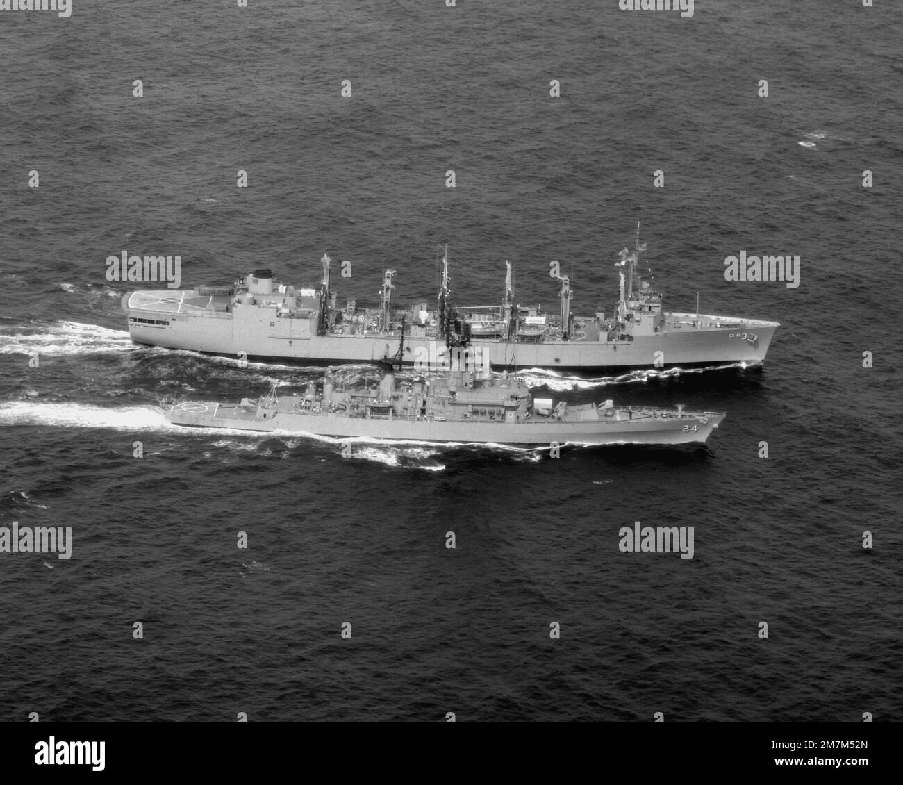The guided missile cruiser USS REEVES (CG-24) steams alongside the ...