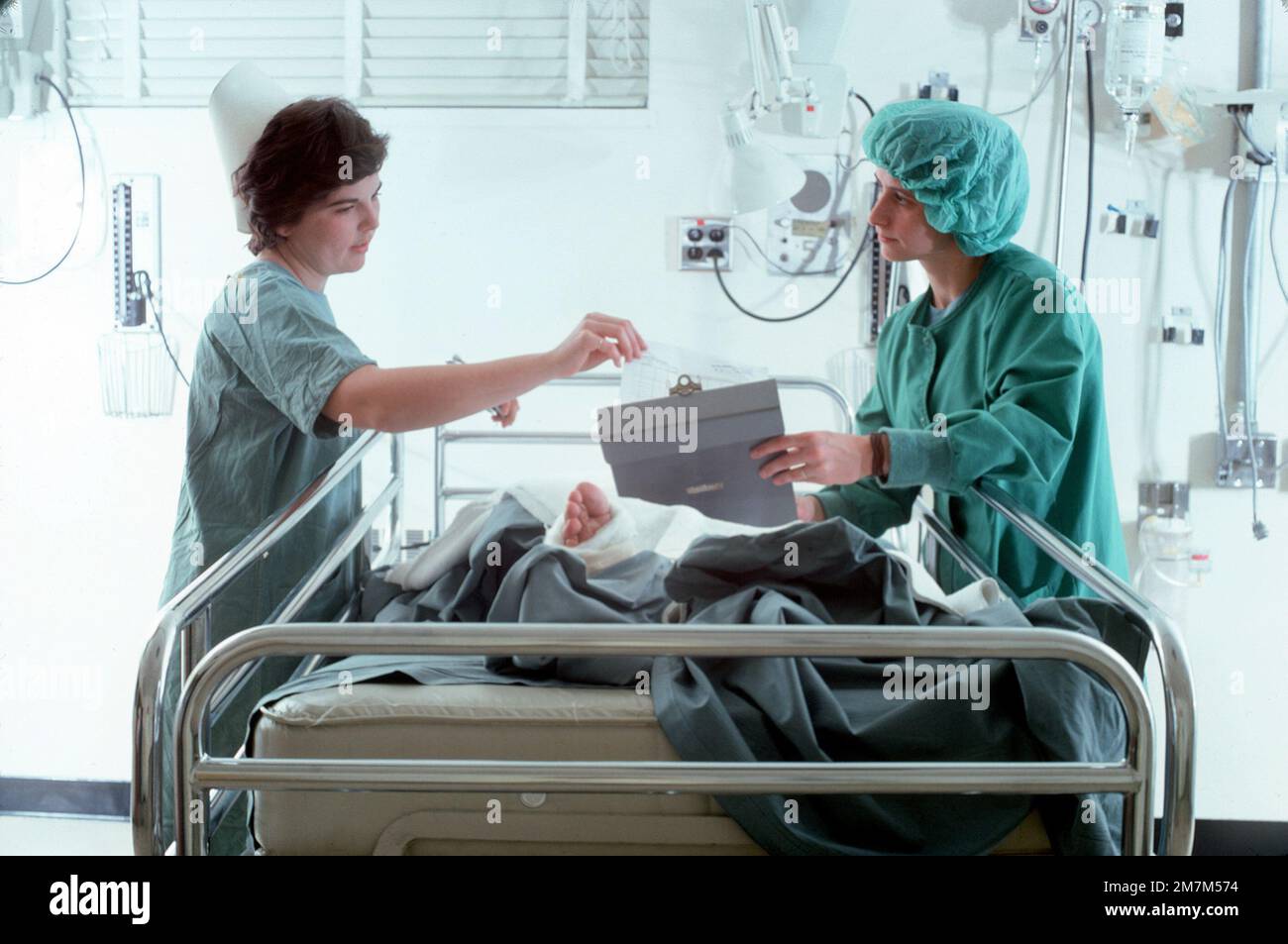 U.S. Army nurses check a patient's chart. Country: Unknown Stock Photo ...