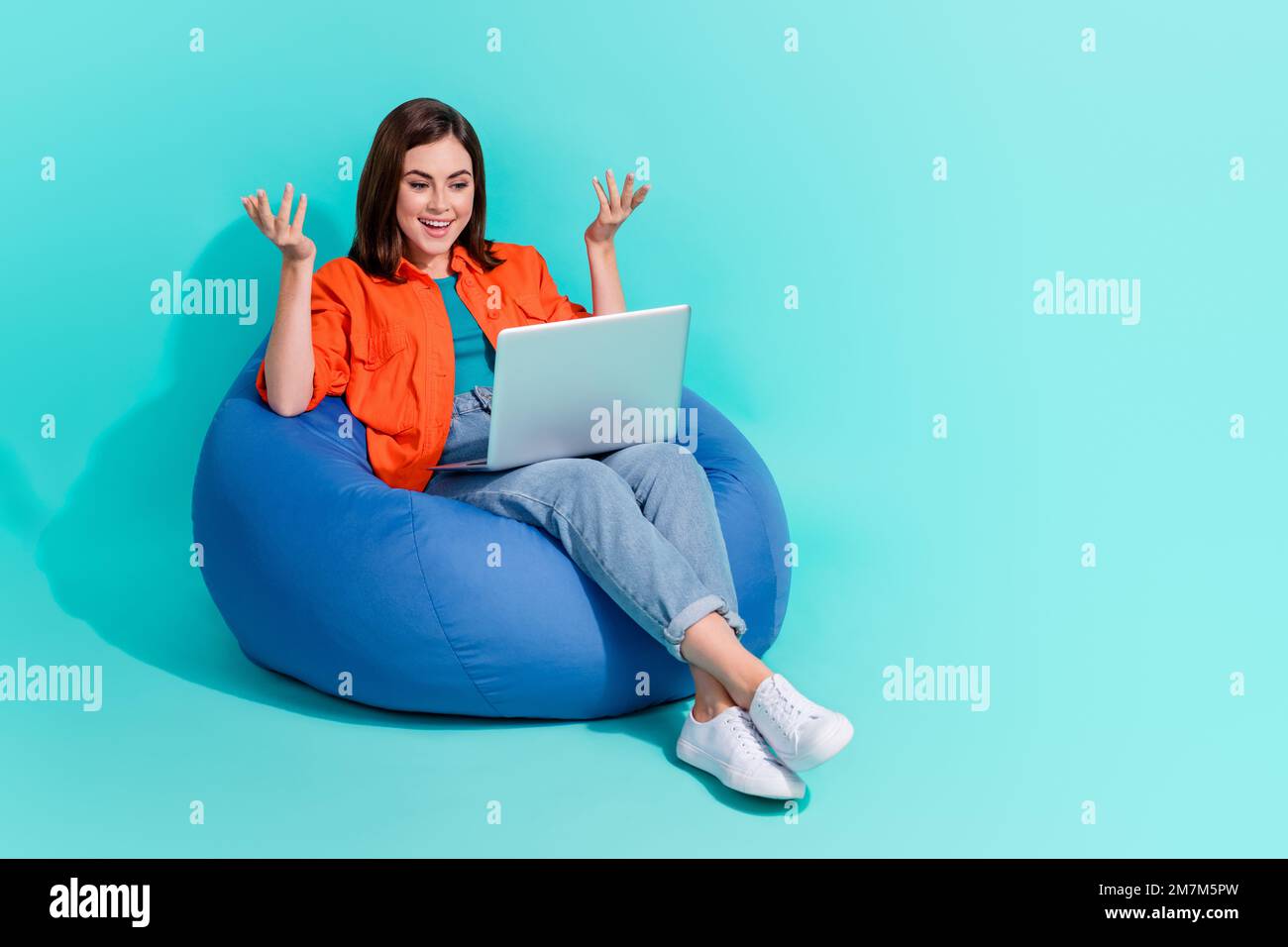 Full length photo of impressed girl dressed orange shirt bean bag ...