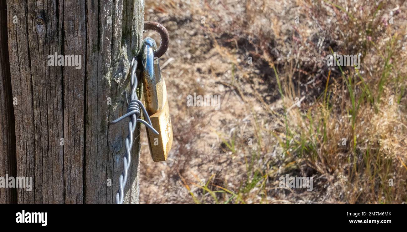 Padlock on barbed wire hi-res stock photography and images - Alamy