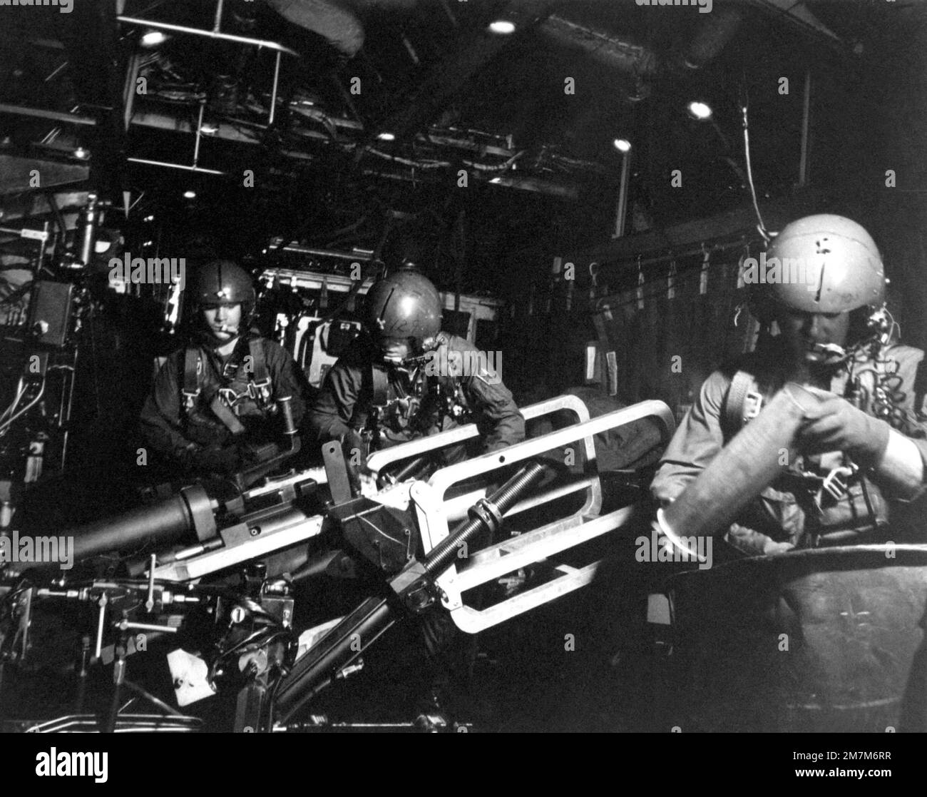Crew members unload and reload a 105mm cannon in an AC-130H Hercules ...