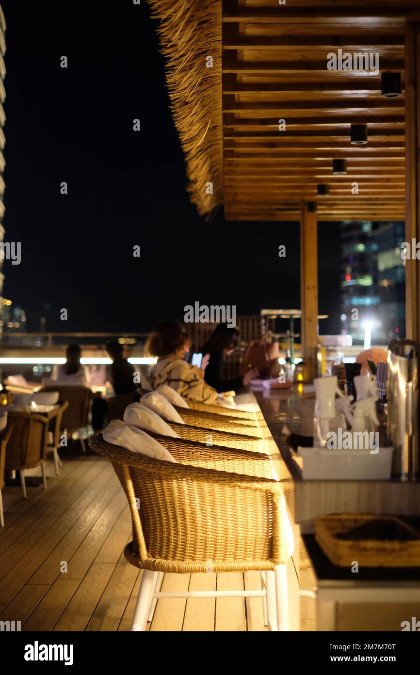 A rooftop bar with tables and chairs Stock Photo - Alamy