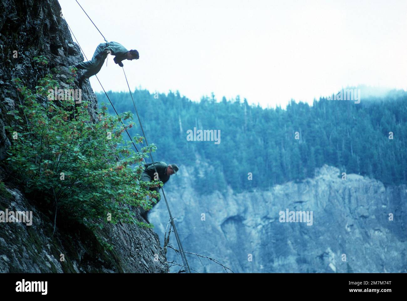 U.S. Army soldiers scale a mountain during a field training exercise ...