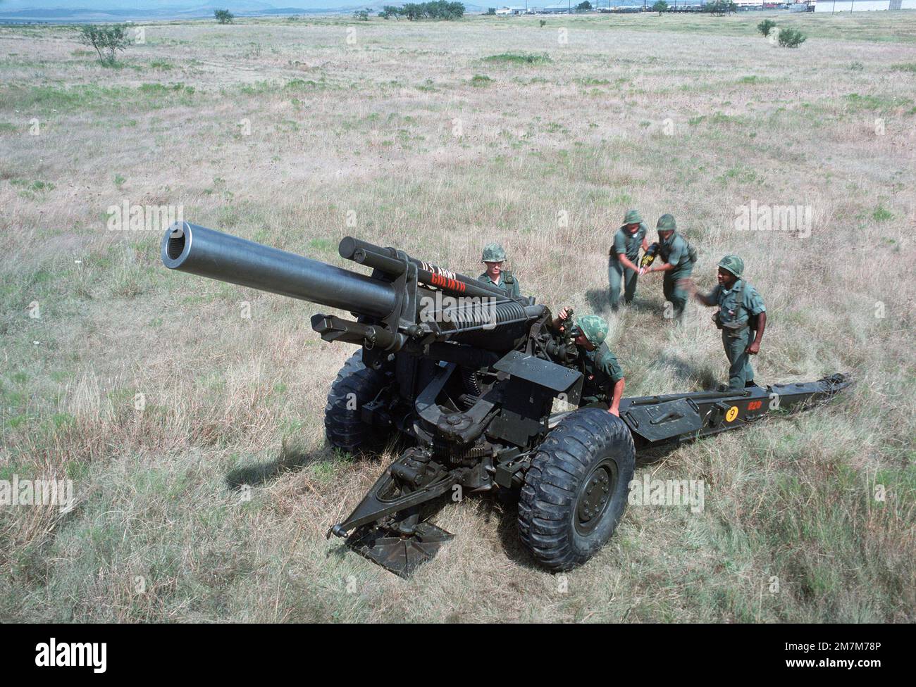 A US Army artillery crew loads an M114 155 mm howitzer during a ...