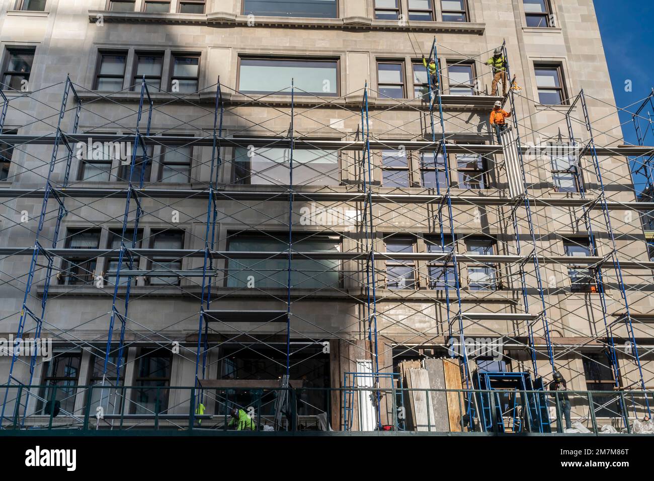 Workers construct scaffolding for facade work in Chelsea in New York on ...
