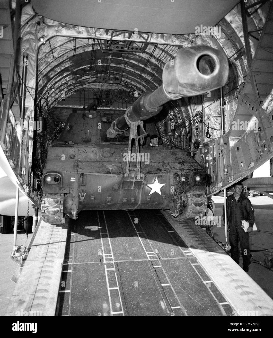 An M-109A1 155mm self-propelled howitzer is offloaded from a YC-15 ...