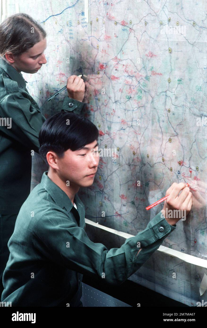 US Army intelligence specialists plot points on a map. Country: Unknown ...