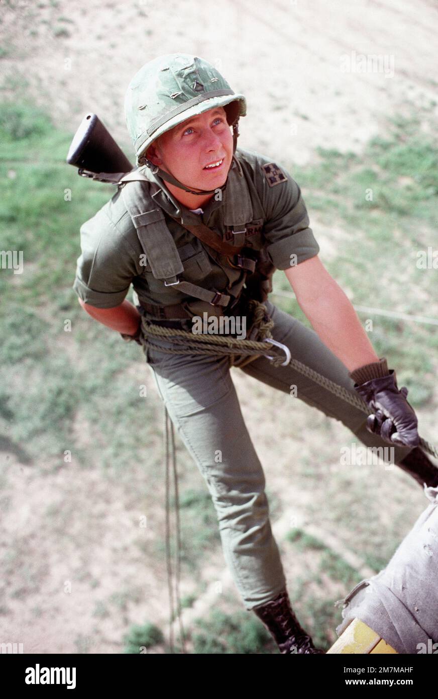 A U.S. Army soldier practices rappelling from a tower during a field ...
