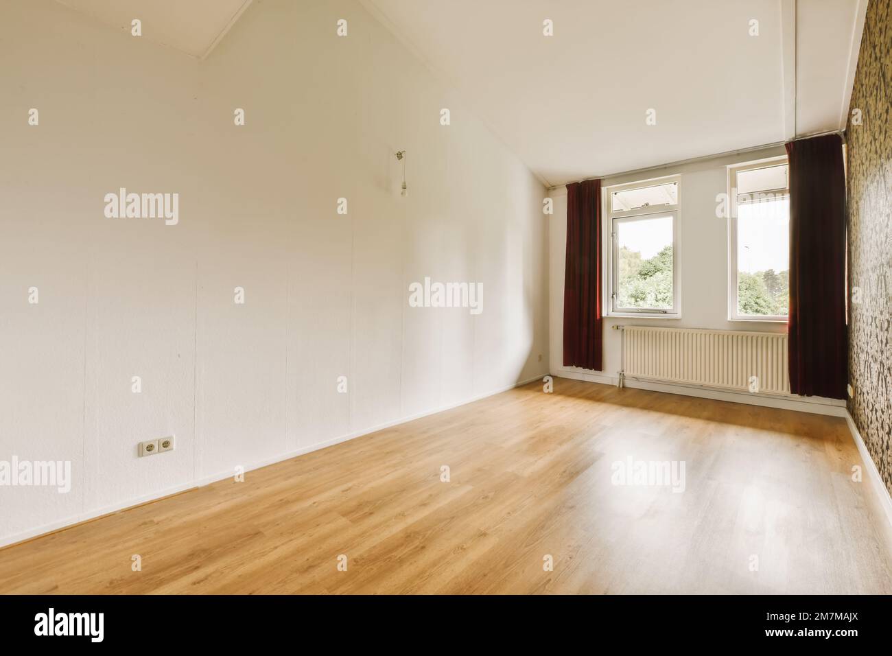 an empty living room with wood flooring and wallpapers on the walls in ...
