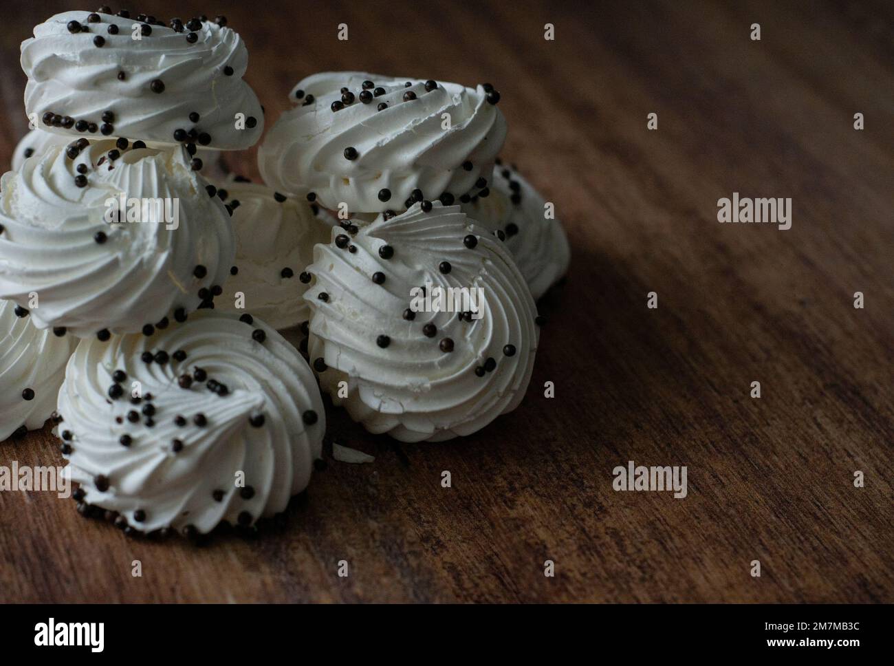 Airy meringue with pieces of chocolate from the top on a white ...