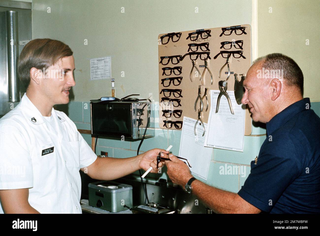 SSGT Paul Catles, an eye specialist, examines Frederick Mayes, USA ...