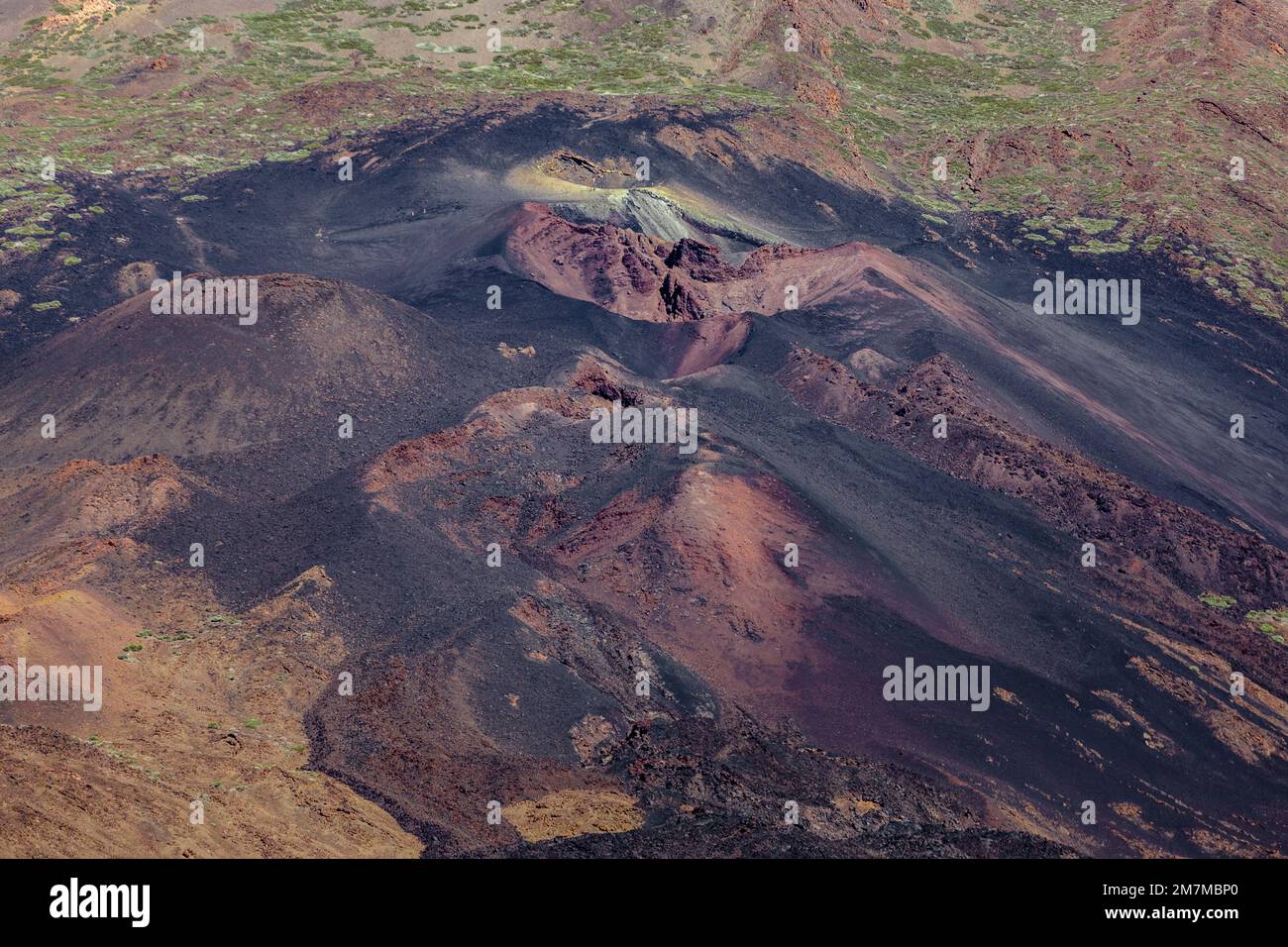 A volcanic side vent on the slopes of the volcano, with black, brown ...