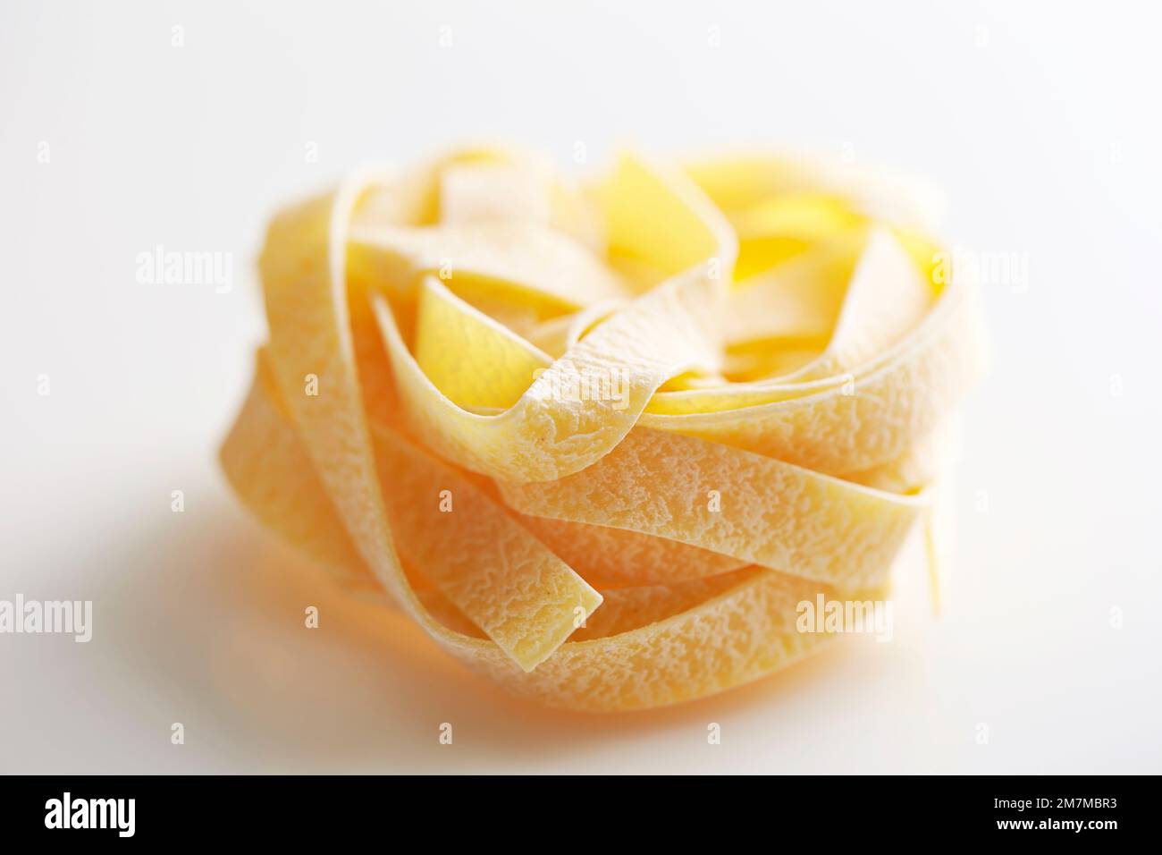 dried pasta on a white background Stock Photo - Alamy