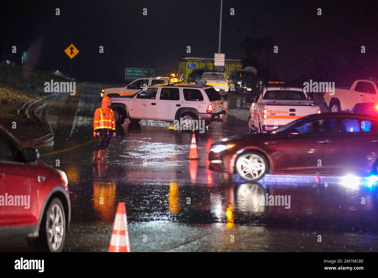 A Caltrans worker directs traffic at a freeway entrance as the U.S ...