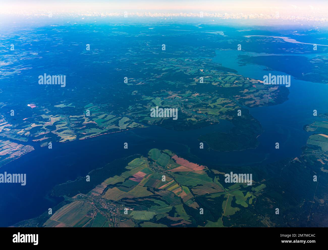 Aerial view from airplane window above green ground. View from the ...