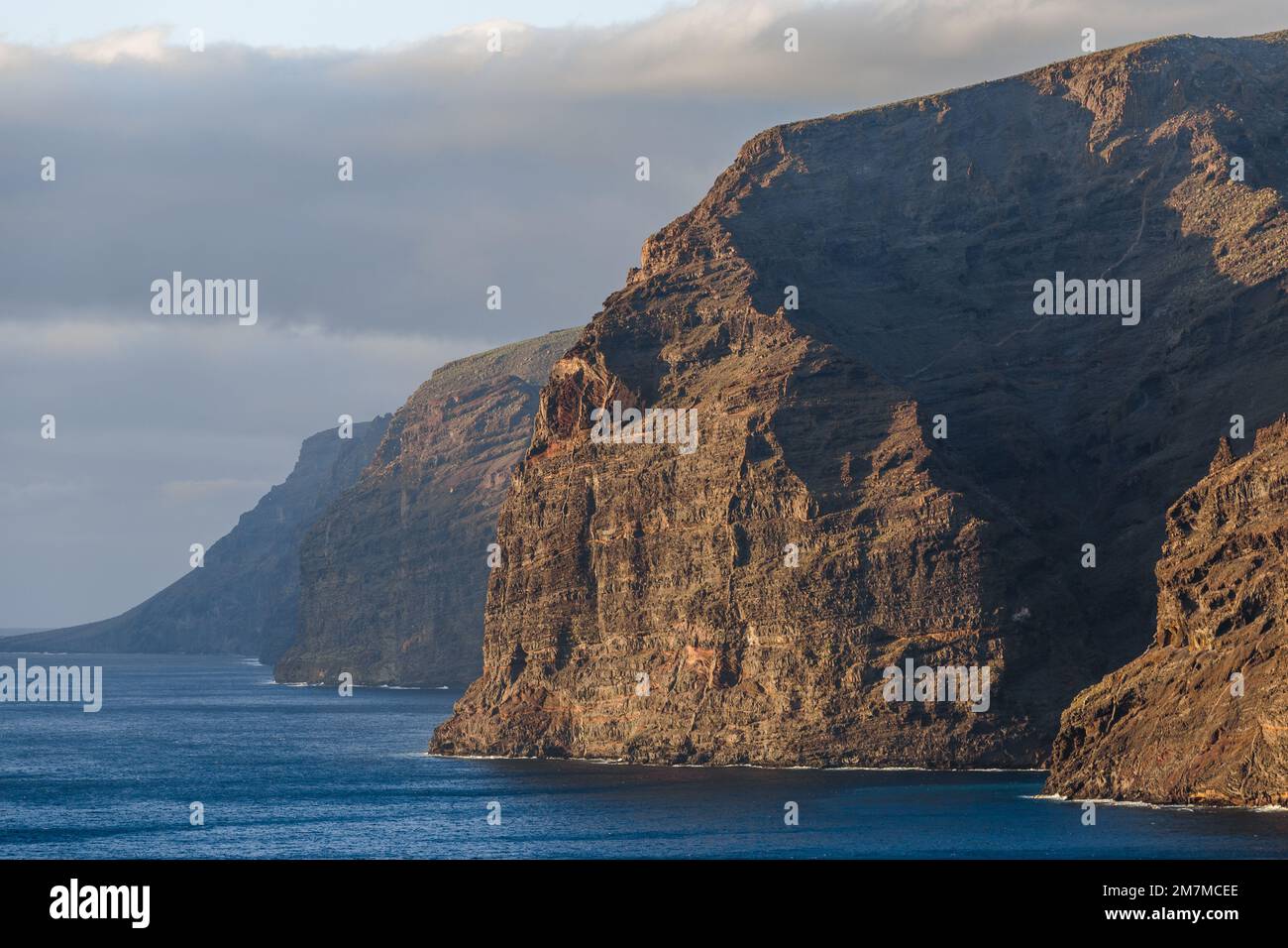 Telephoto view of the sunlit iconic massive cliffs rising out of the ...