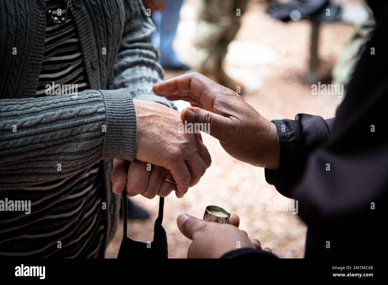 A priest anoints the hands of a Naval Health Clinic Cherry Point staff ...
