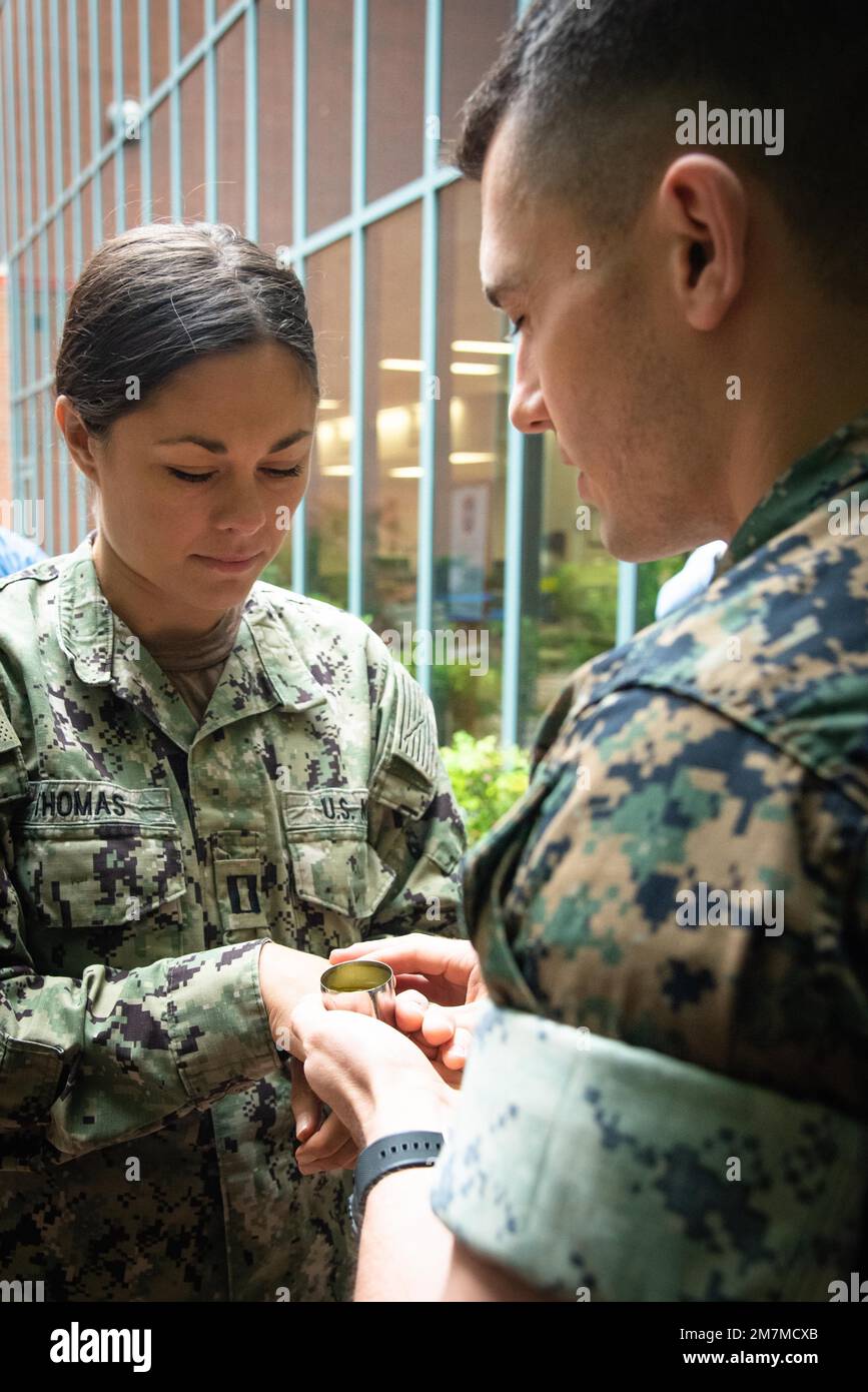 Navy Lieutenant Junior Grade Chaplain Kyle Lambertson, right, anoints ...
