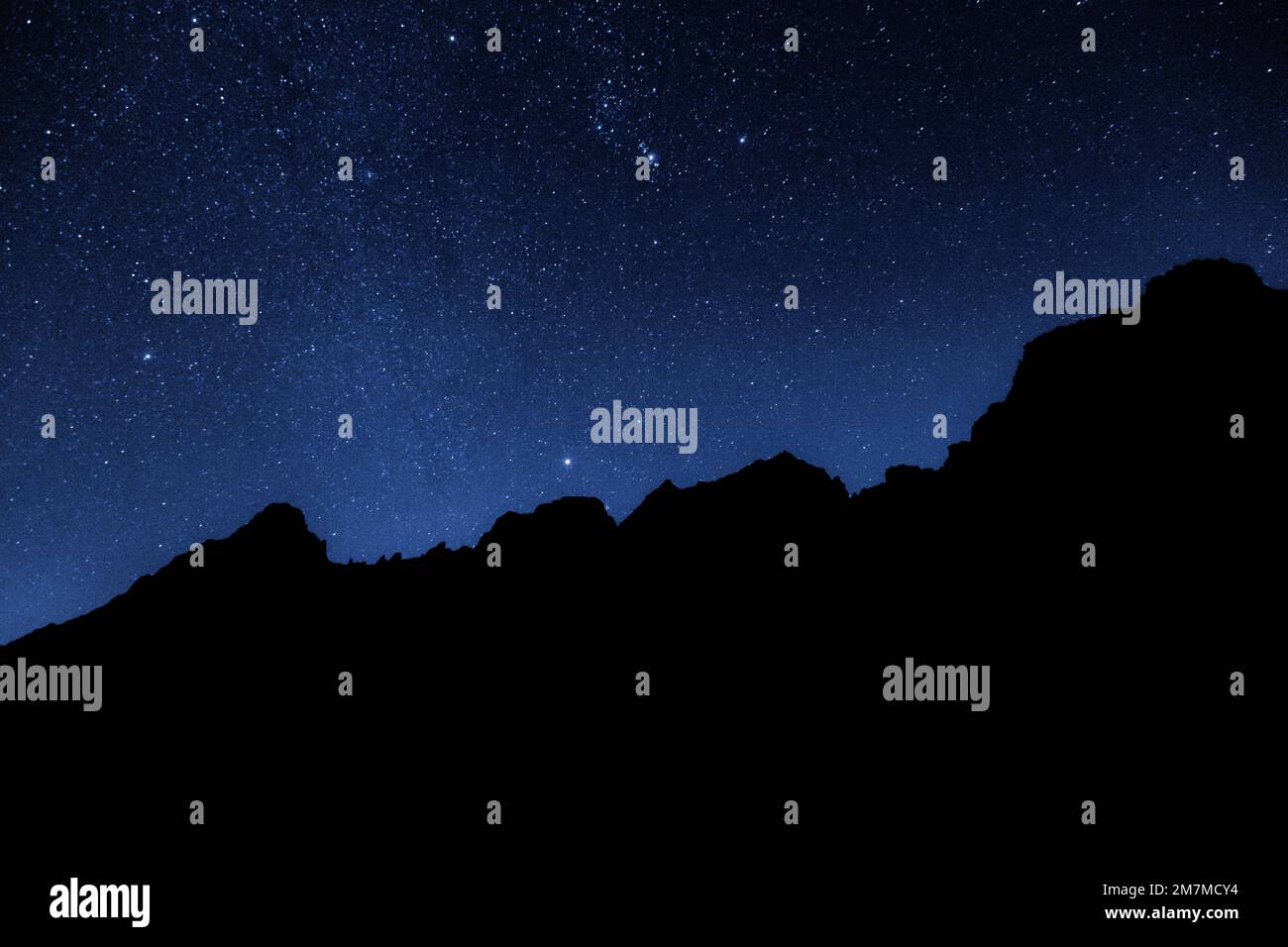 Silhouette of the tall rocks with the dark blue night sky and subtle ...